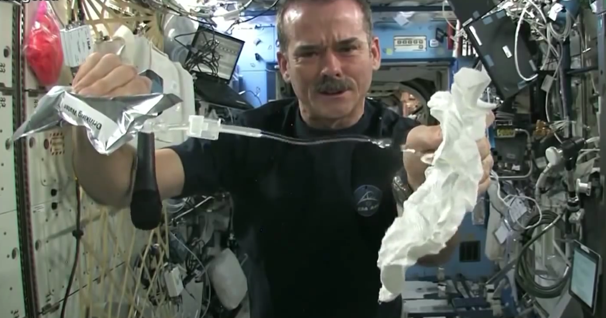 Astronaut Wrings A Wet Towel In Space | Bored Panda